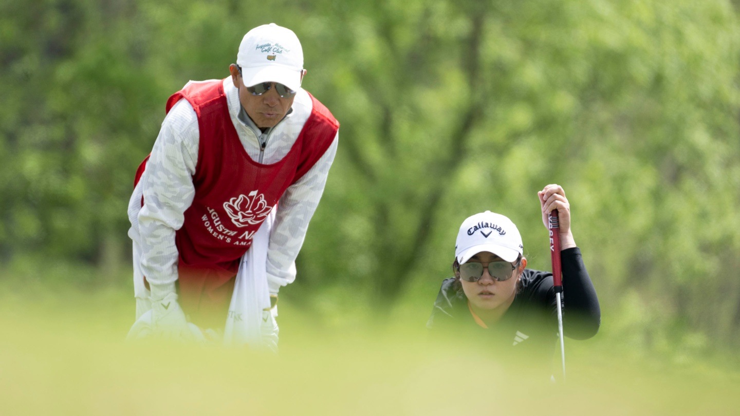 Rose Zhang of the United States and her caddie Haibin Zhang line up a ...