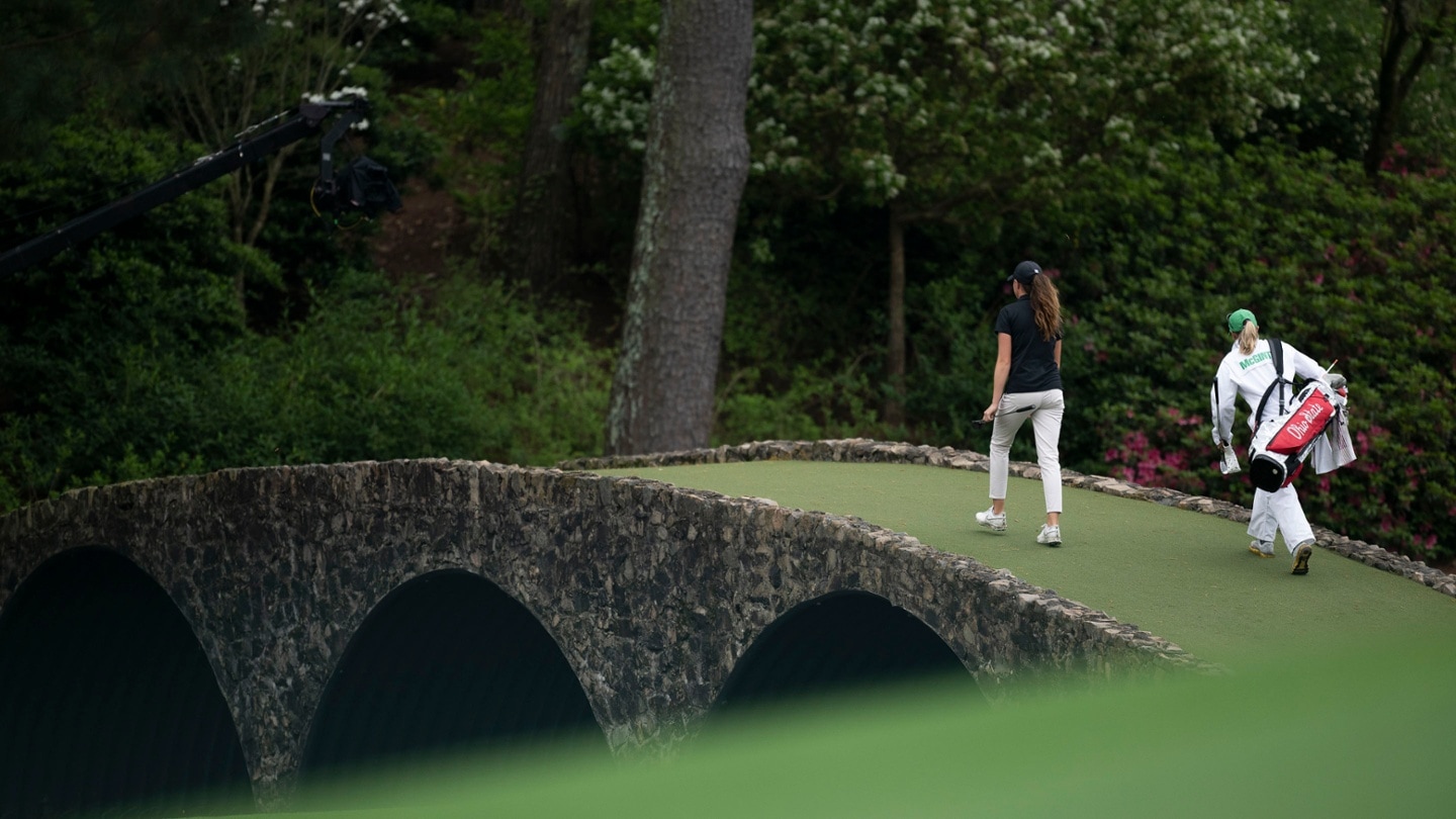 Caley McGinty walks over the Hogan Bridge on No. 12 during the final ...