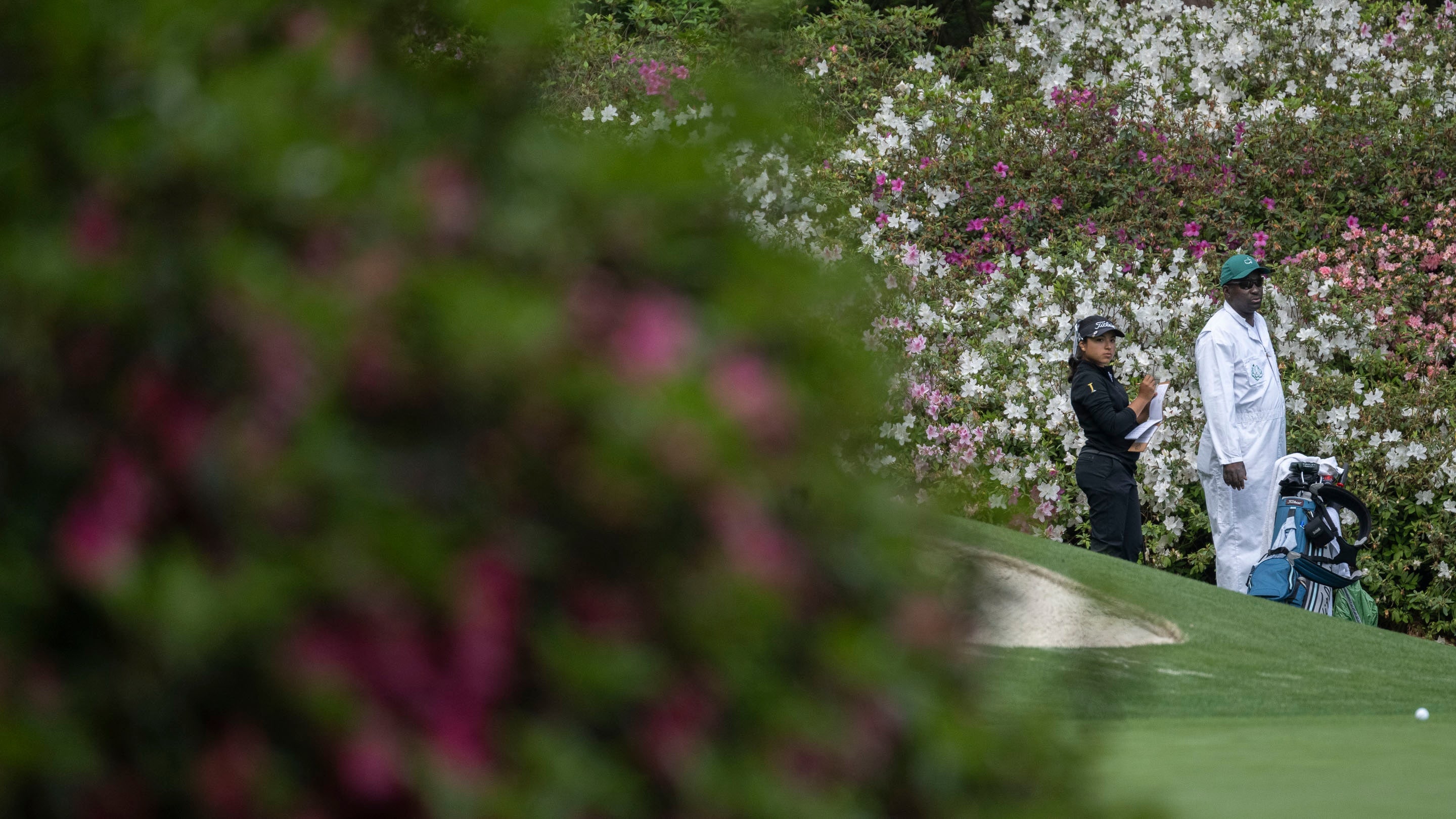 Maria Jose Marin of Colombia and her caddie look on from the No.12 ...