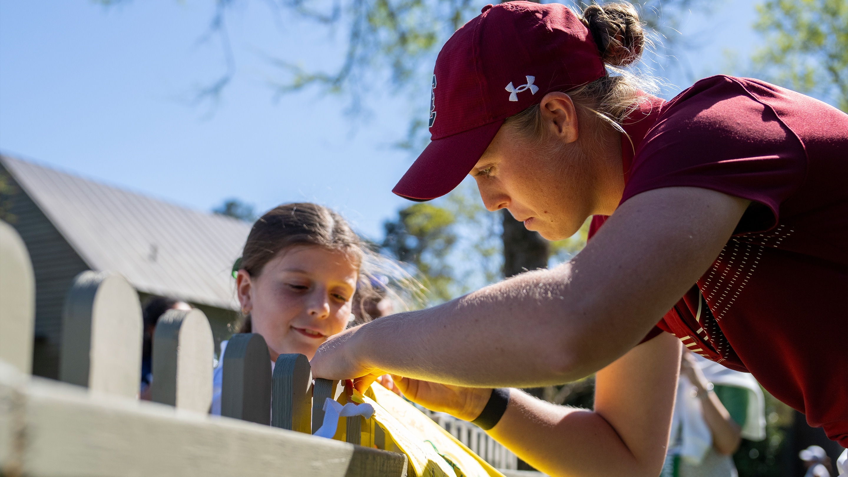 Hannah Darling of Scotland signs her autograph for a young patron ...